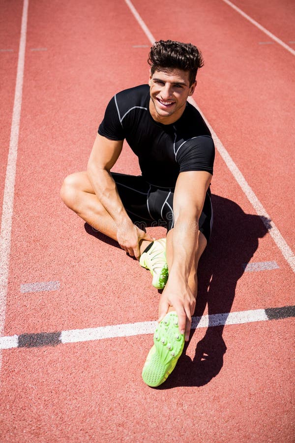 Tired Athlete Sitting on the Running Track Stock Photo - Image of ...