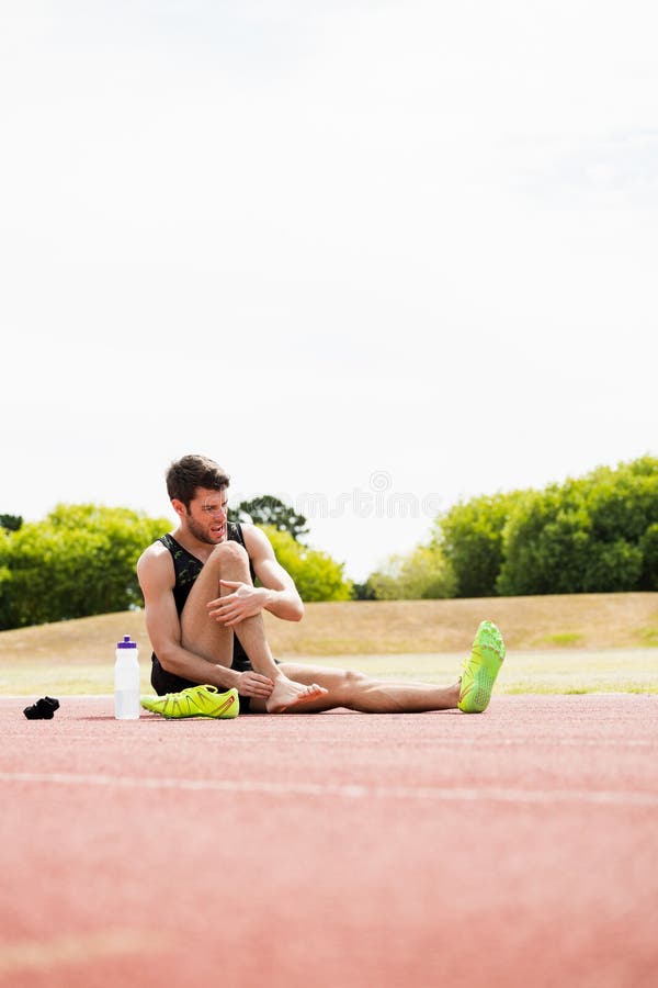 Tired Athlete Sitting on the Running Track Stock Photo - Image of sunny ...