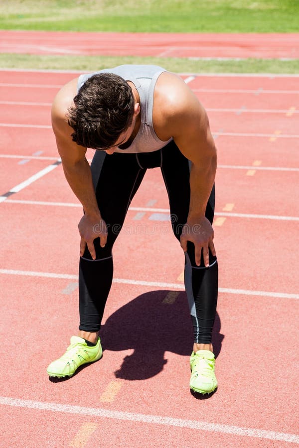 Tired Athlete Sitting on the Running Track Stock Image - Image of male ...