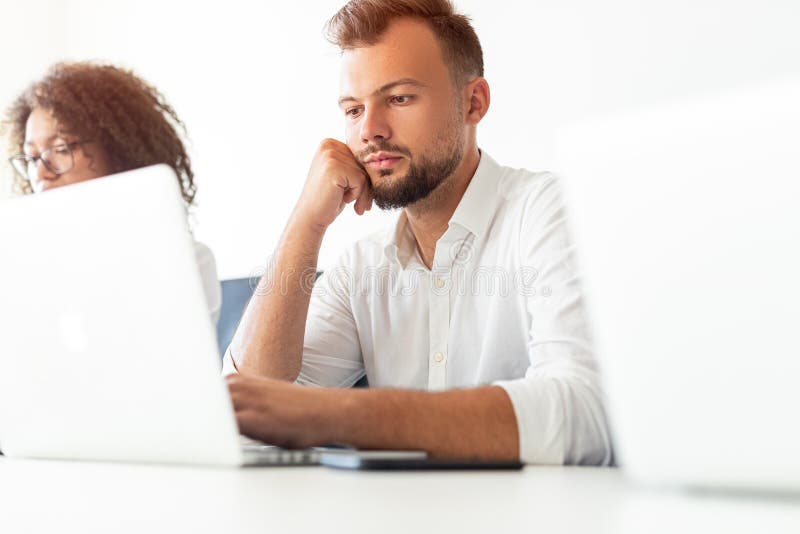 Bored Office Worker Using Laptop Stock Image - Image of indoors, modern ...