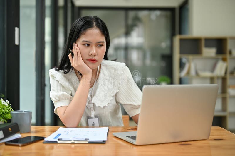 Tired and Bored Young Asian Female Office Worker is Working on Her Project at Her Desk Stock ...