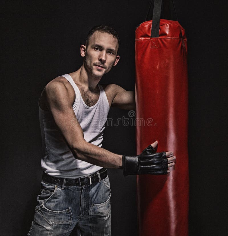 Photo of Aggressive Athlete and Red Boxing Bag Stock Image - Image of ...