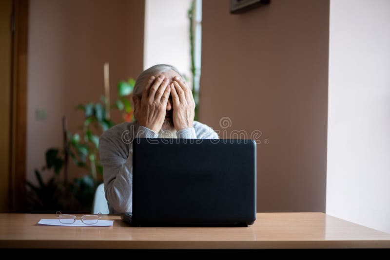 A Tired, Broken, Resigned, Preoccupied Elderly Man Sits in Front of a ...