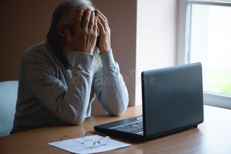 A Tired, Broken, Resigned, Preoccupied Elderly Man Sits in Front of a ...