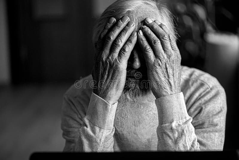 A Tired, Broken, Resigned, Preoccupied Elderly Man Sits in Front of a ...