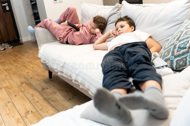 Tired Children Lie on a Comfortable Sofa after a Hard Day at School ...