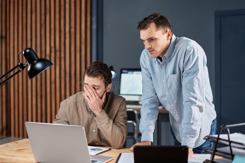 Tired Colleagues Working with Financial Documents at Night. Stock Photo ...