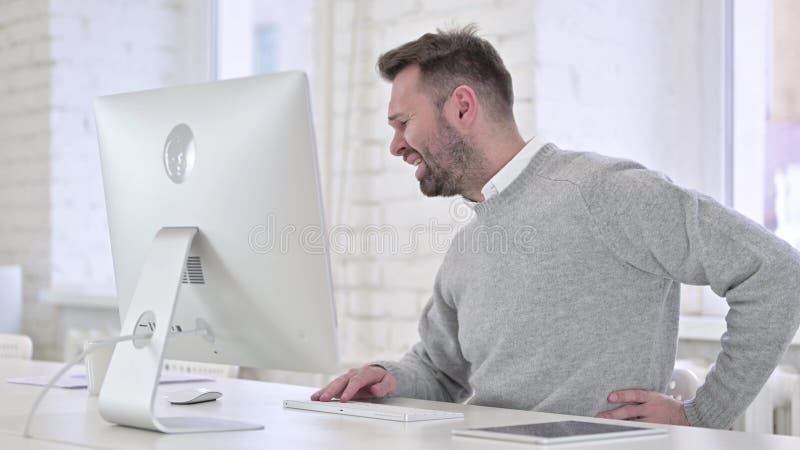 Tired Creative Man Having Back Pain at Work Stock Photo - Image of busy ...