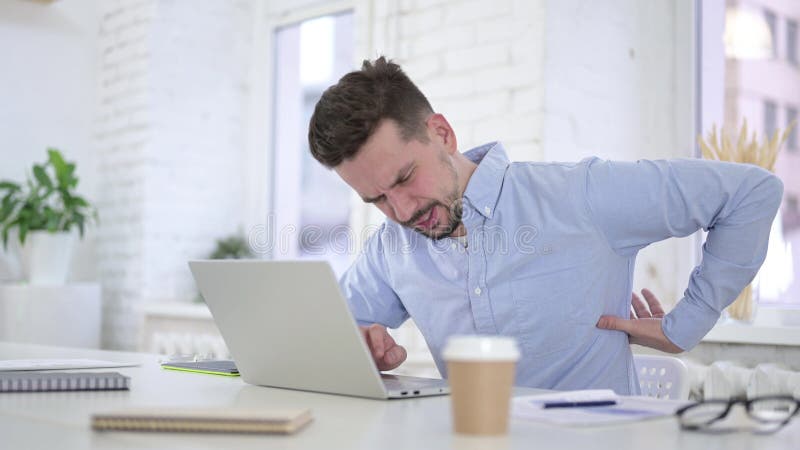 Tired Creative Young Man Having Back Pain at Work Stock Photo - Image ...