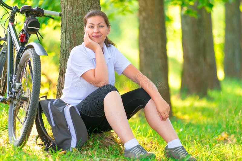 Tired Cyclist Resting in a Park Stock Image - Image of cheerful, green ...
