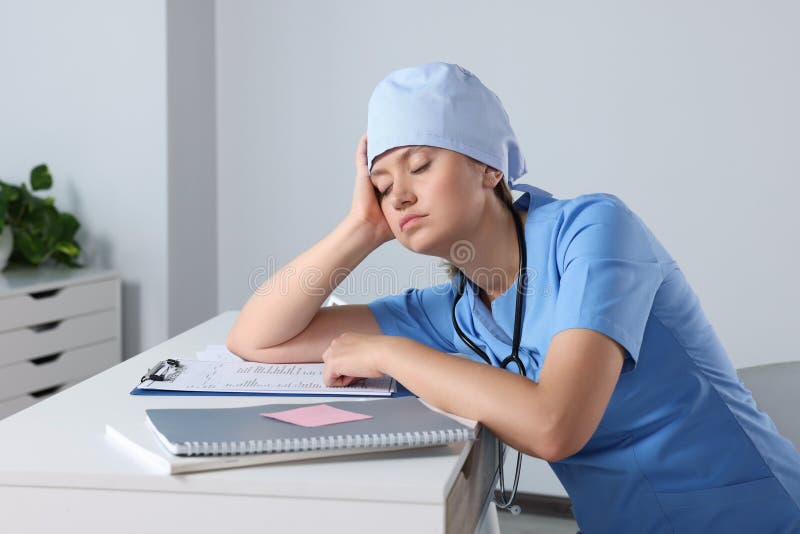 Tired Young Doctor Sleeping at Workplace in Office Stock Photo - Image ...