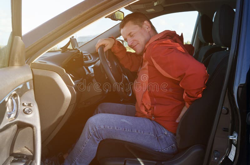 A Tired Driver Holds on To His Back, Which Hurts after a Long Drive ...