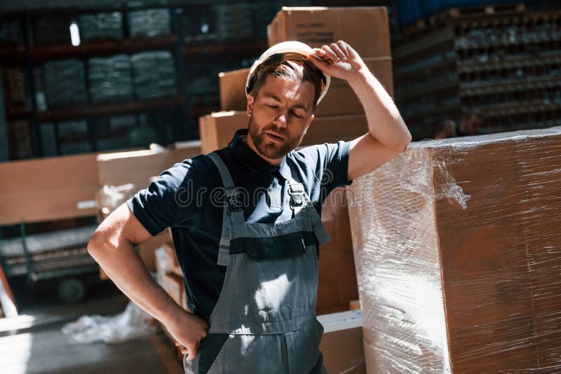 Tired Employee in Uniform is Working in the Dark Storage Stock Image ...