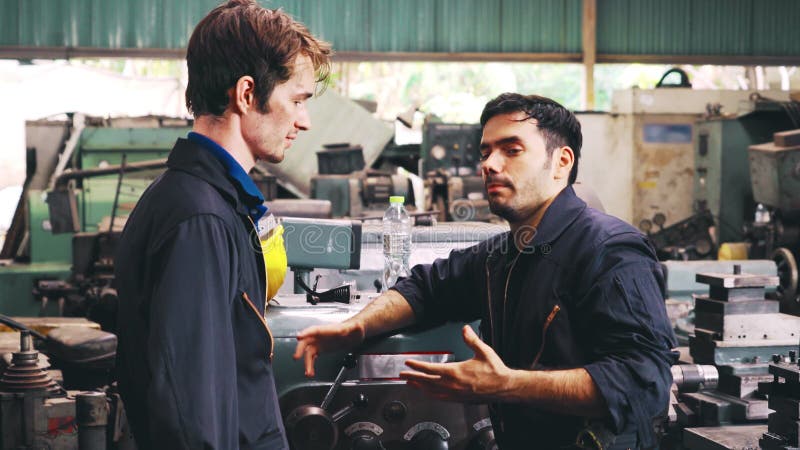 Tired Factory Workers Taking a Break and Talking To Coworker in the ...