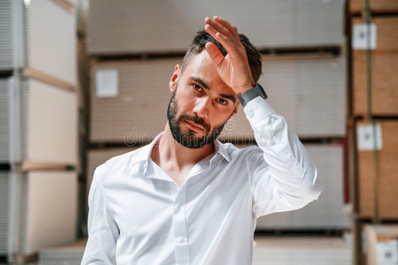 Tired, Feeling Bad. Storage Worker is in the Warehouse with Bunch of ...