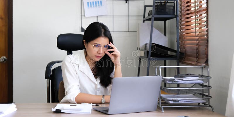 Tired Female Employee Holding Head on Hand, Looking at Computer Screen ...