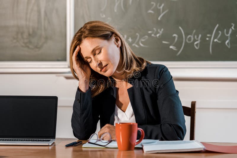 Tired Female Teacher with Eyes Closed Sitting at Computer Desk Stock ...