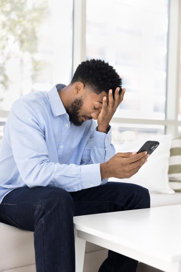Tired Frustrated Young African Man Having Problems with Mobile Phone ...