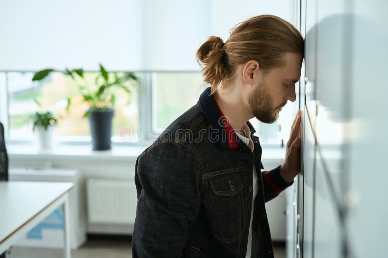 Tired Guy Leaned His Forehead Against the Locker Stock Photo - Image of ...