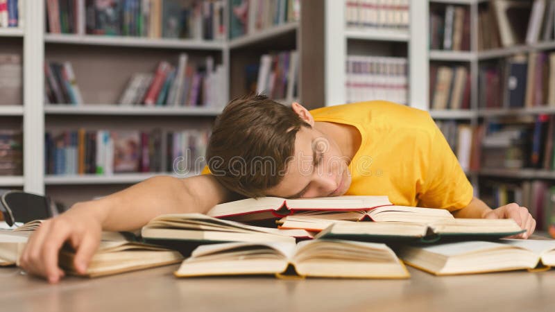 Tired Guy Napping on Books in Library Stock Image - Image of education ...