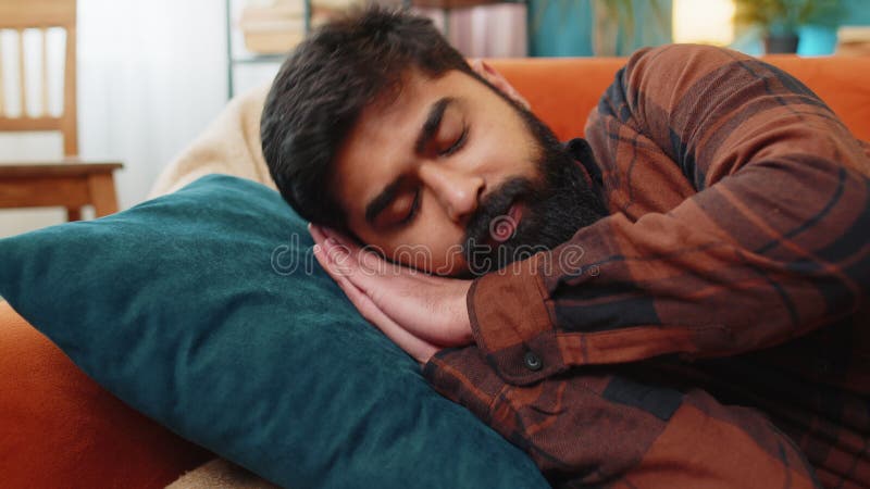 Tired Indian Handsome Young Man Guy Enjoy Relaxing Lying on Sofa in ...