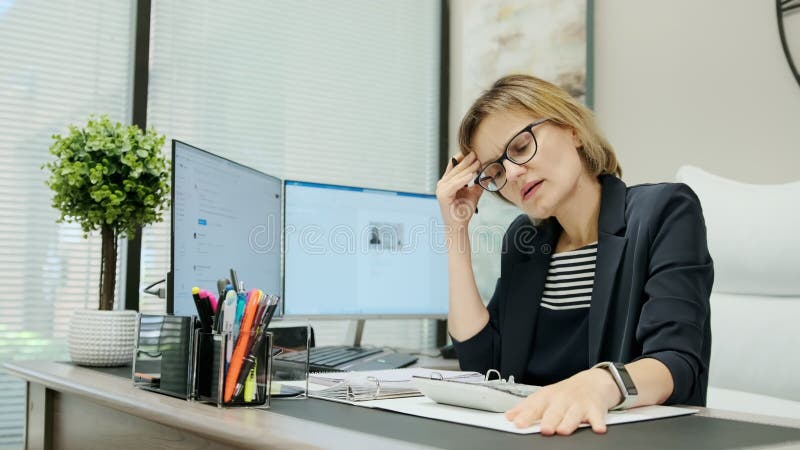 Tired and Irritated Woman Sit at Desk Using Computer, Make Data ...