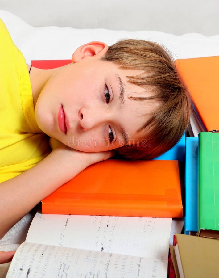 Tired Kid with a Books stock image. Image of interior - 82347787