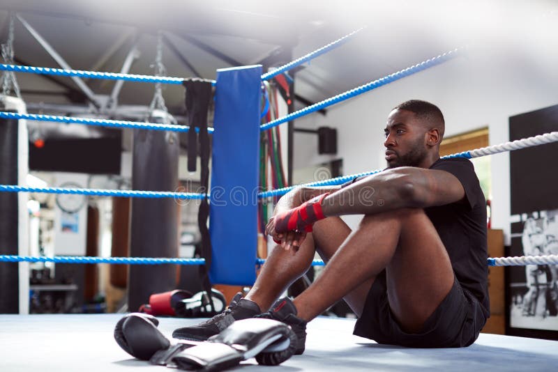 Tired Male Boxer Sitting in Boxing Ring in Gym after Training Session ...