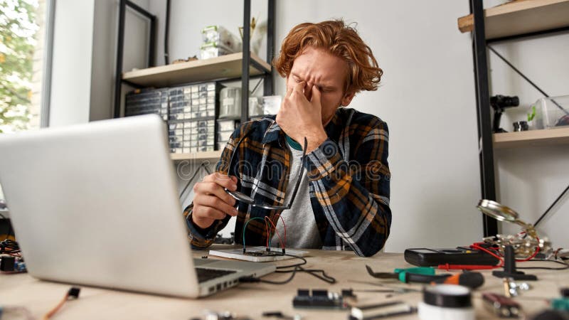 Tired Male it Engineer Using and Working on Laptop Stock Photo - Image ...