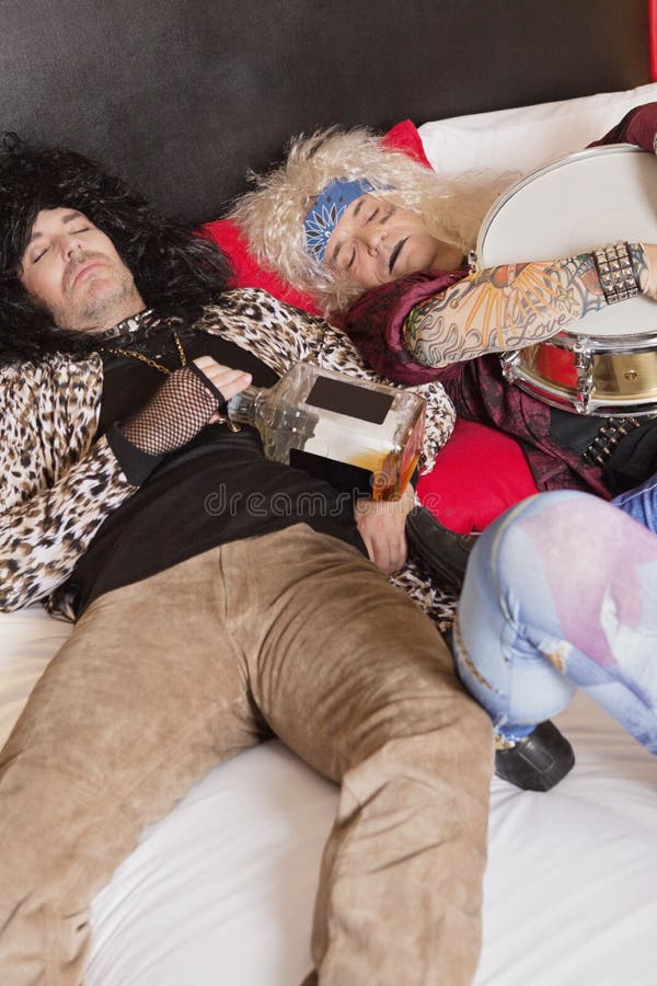 Tired Male Friends Sleeping on Bed Stock Photo - Image of bottle ...