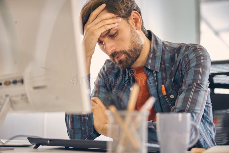 Exhausted Young Man Using Computer at Work Stock Photo - Image of ...