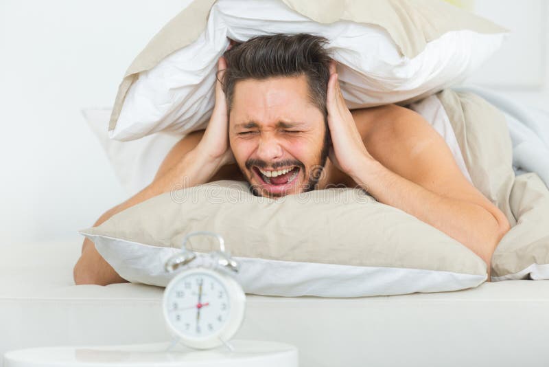 Tired man in bed not happy stock photo. Image of unhappy - 241148698
