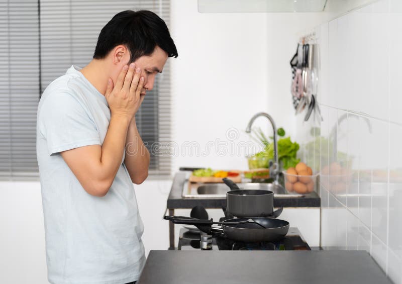 Tired Man Cooking and Preparing Food in the Kitchen at Home Stock Image ...