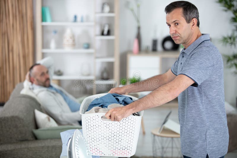 Tired Man Doing Laundry at Home Stock Photo - Image of work ...