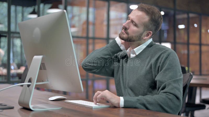 Tired Man Having Neck Pain while Working on Computer Stock Photo ...
