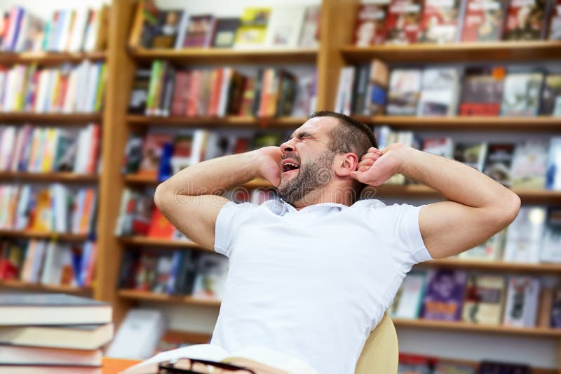Tired man in the library stock image. Image of people - 49513673