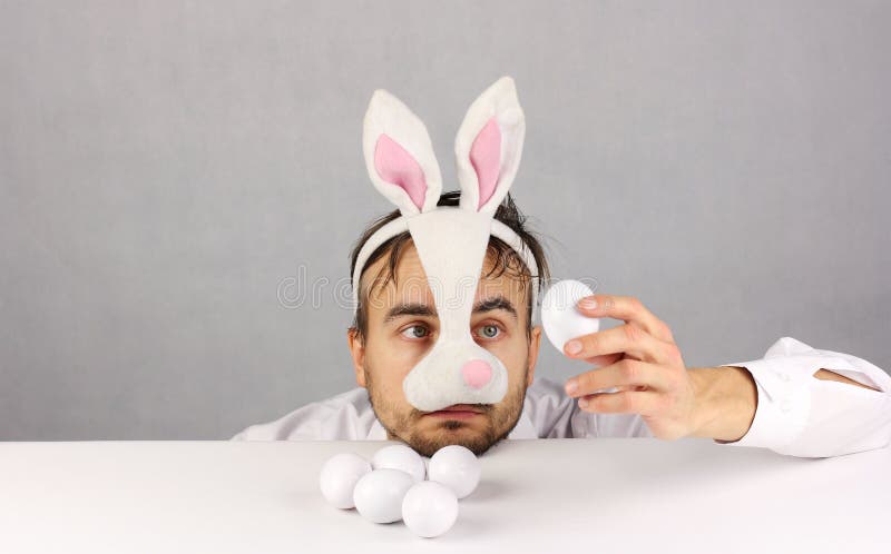 Tired Man in the Mask Easter Bunny Looking at the Egg Stock Photo ...
