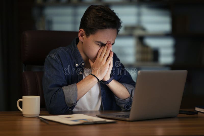 Tired Man Sitting in Front of Computer at Dark Office Stock Image ...