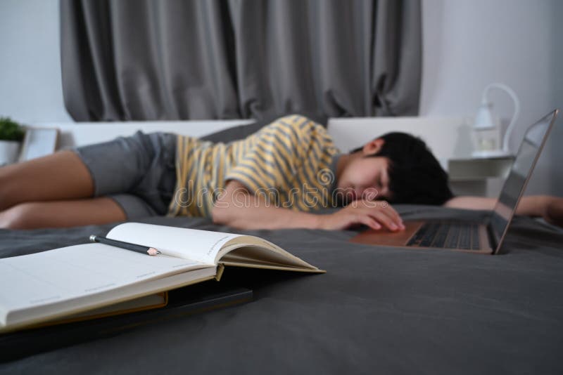 Tired Man Sleeping on Bed with Laptop. Stock Photo - Image of exam ...