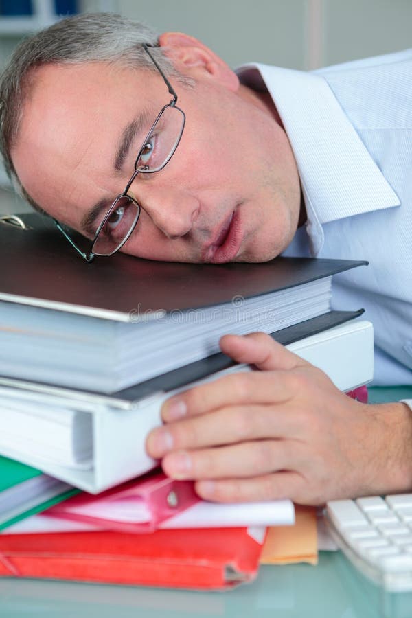 Tired man with stack books stock image. Image of beverage - 100429669