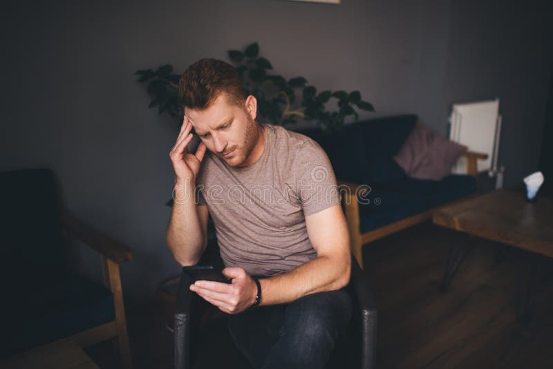 Tired Man Using Mobile Phone while Sitting with Hand on Head Stock ...