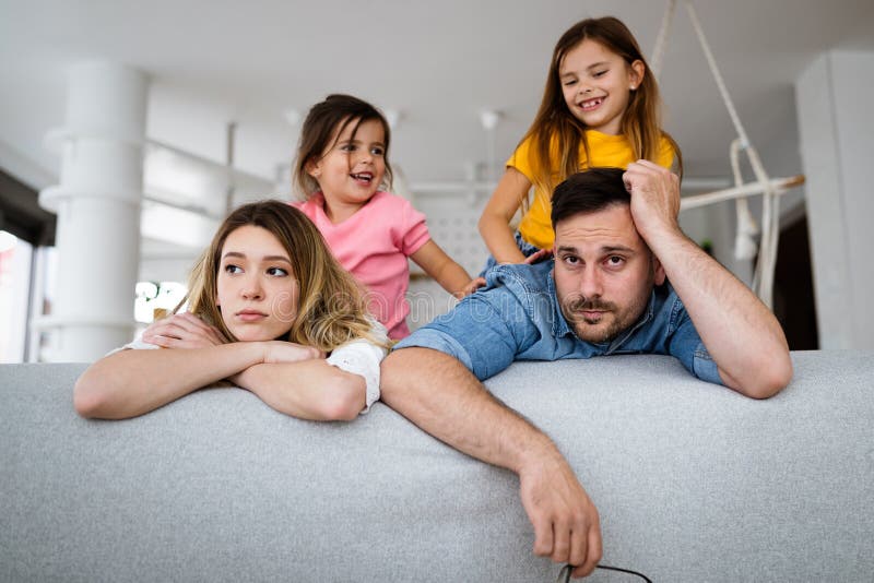 Tired Mother And Father Sitting On Couch Feels Annoyed Exhausted