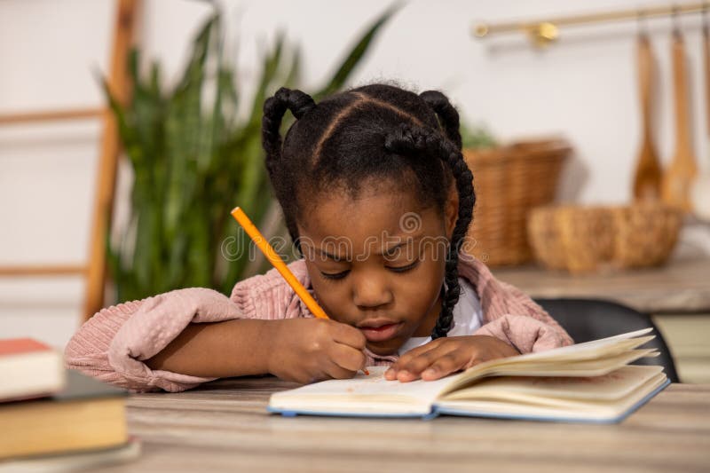 Tired Multicultural Girl Writing in Her Exercise Book with Sad ...