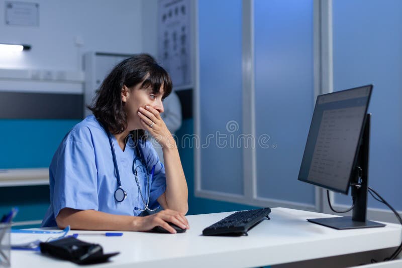 Tired Nurse Using Computer on Desk while Falling Asleep Stock Photo ...