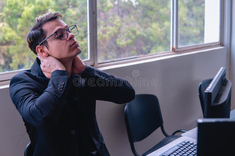 Tired Office Worker after a Day of Work. Man at a Desk Craning His Neck ...