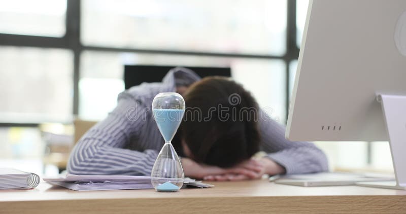 Tired Office Worker Dozing at Desk with an Hourglass Stock Video ...