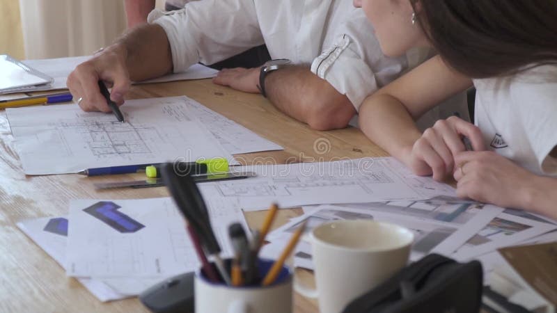 Tired Office Workers Discuss about Drawings, Architectural Drawings ...