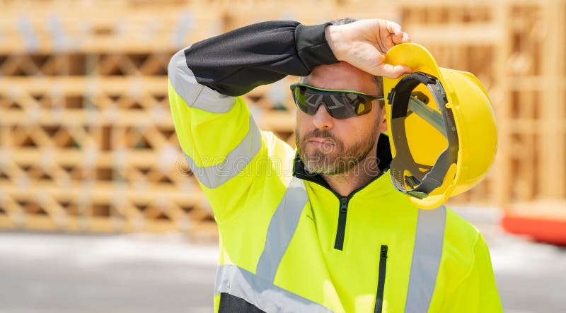 Tired, Overworked Worker in Building Uniform on Buildings Construction ...