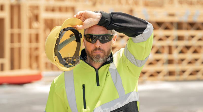 Tired, Overworked Worker in Building Uniform on Buildings Construction ...