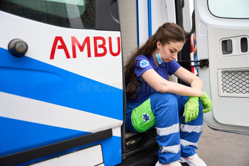 Tired Paramedic Sat Down on the Footrest in an Ambulance Stock Photo ...